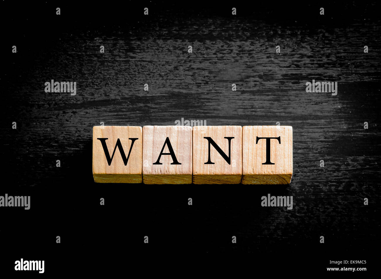 Word WANT. Wooden small cubes with letters isolated on black background ...