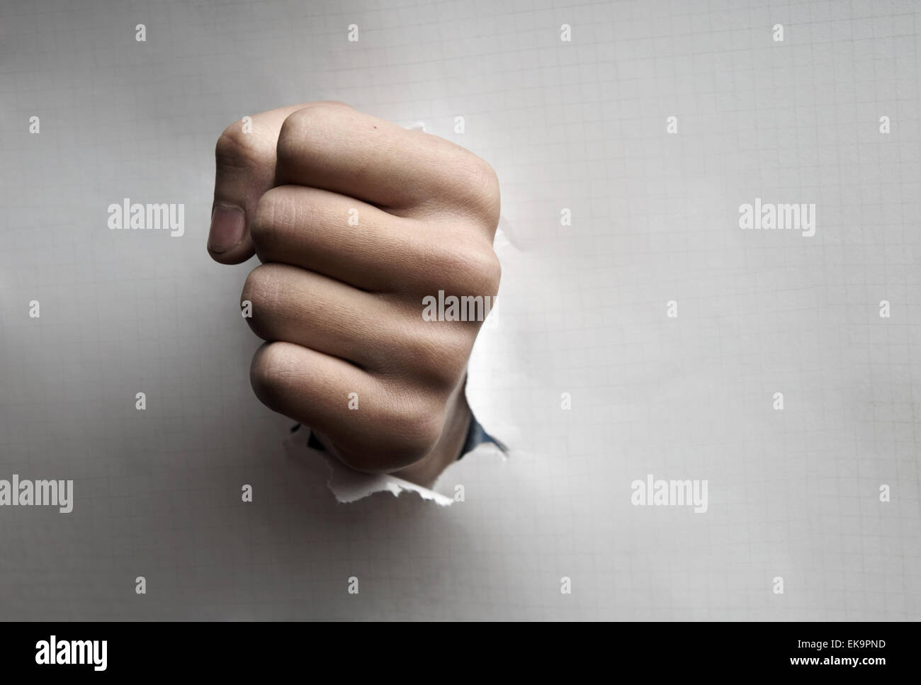 Fist punching through paper hi-res stock photography and images - Alamy