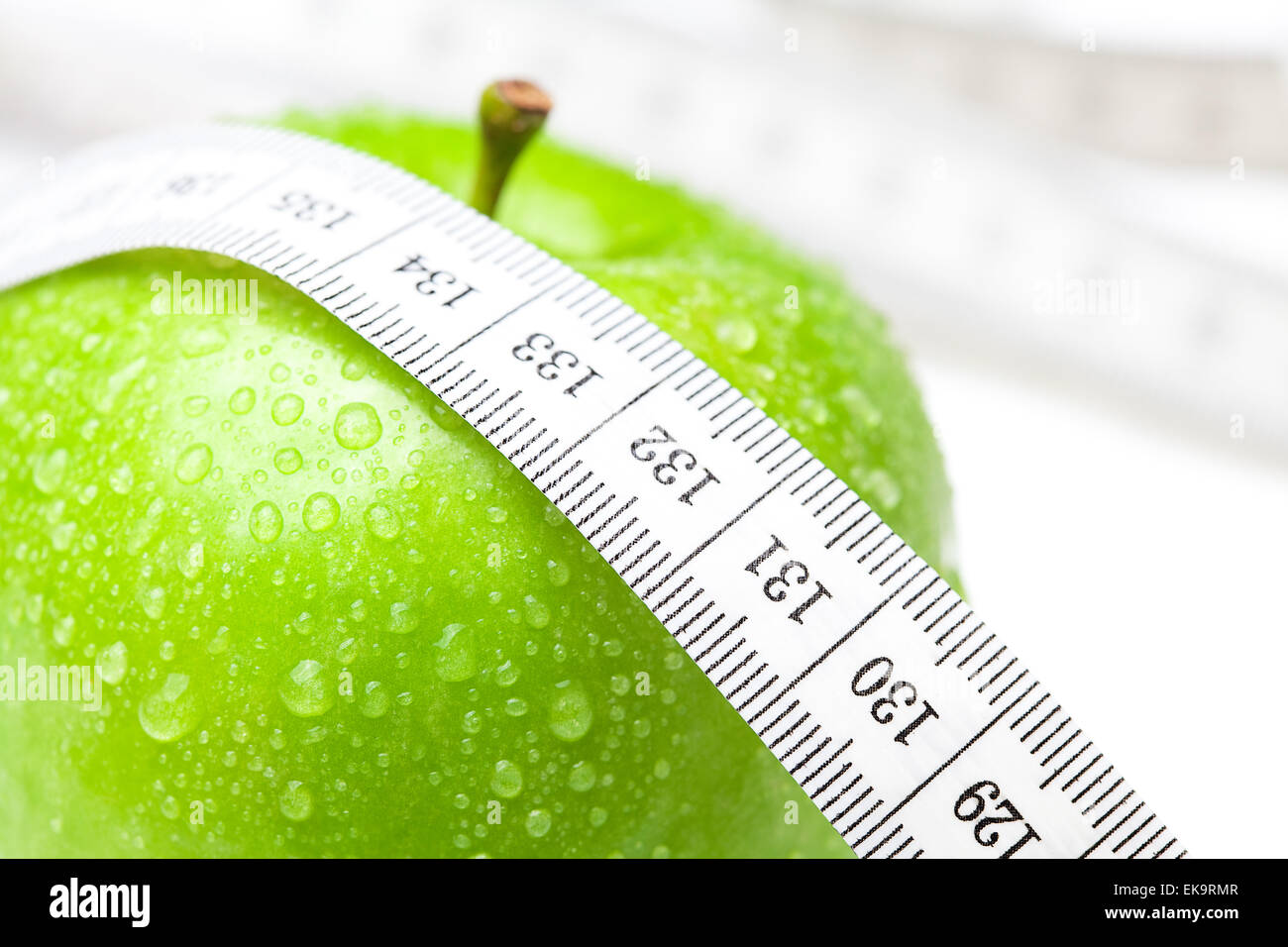 apple and measure tape isolated on white Stock Photo - Alamy