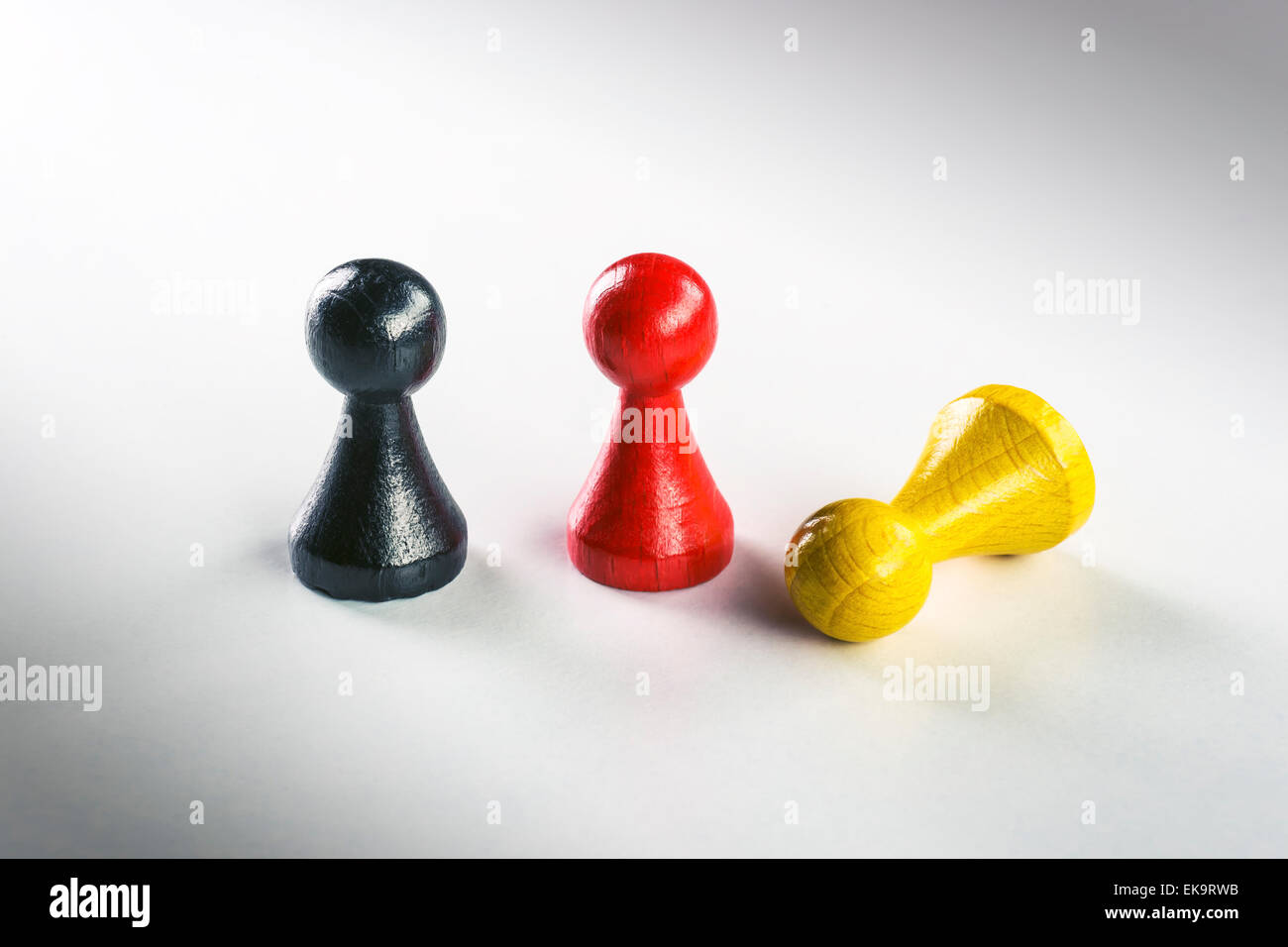Standing black and red and lying yellow Ludo figure Stock Photo - Alamy