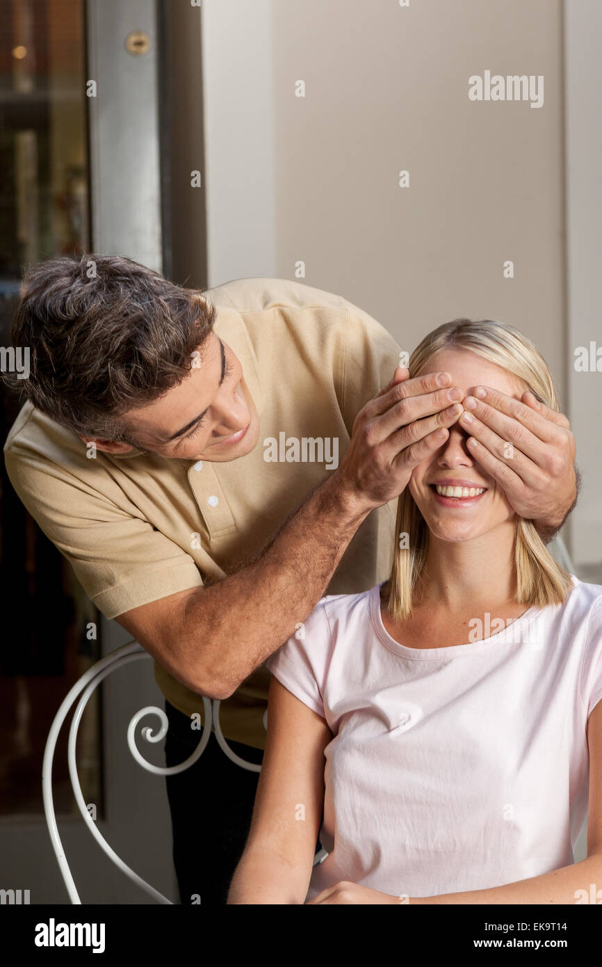 Husband giving a surprise for his wife Stock Photo - Alamy