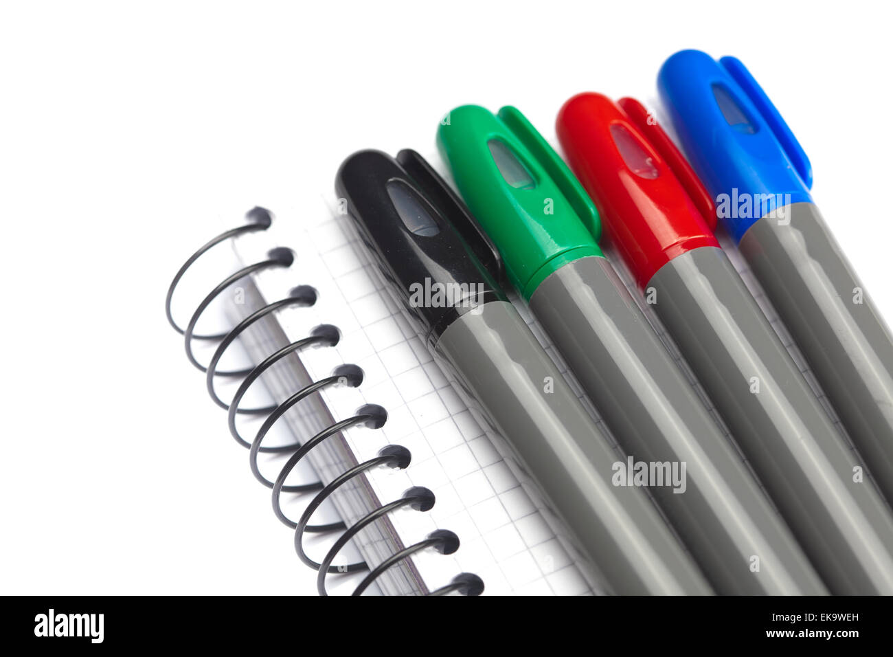colored markers and a notebook isolated on white Stock Photo - Alamy