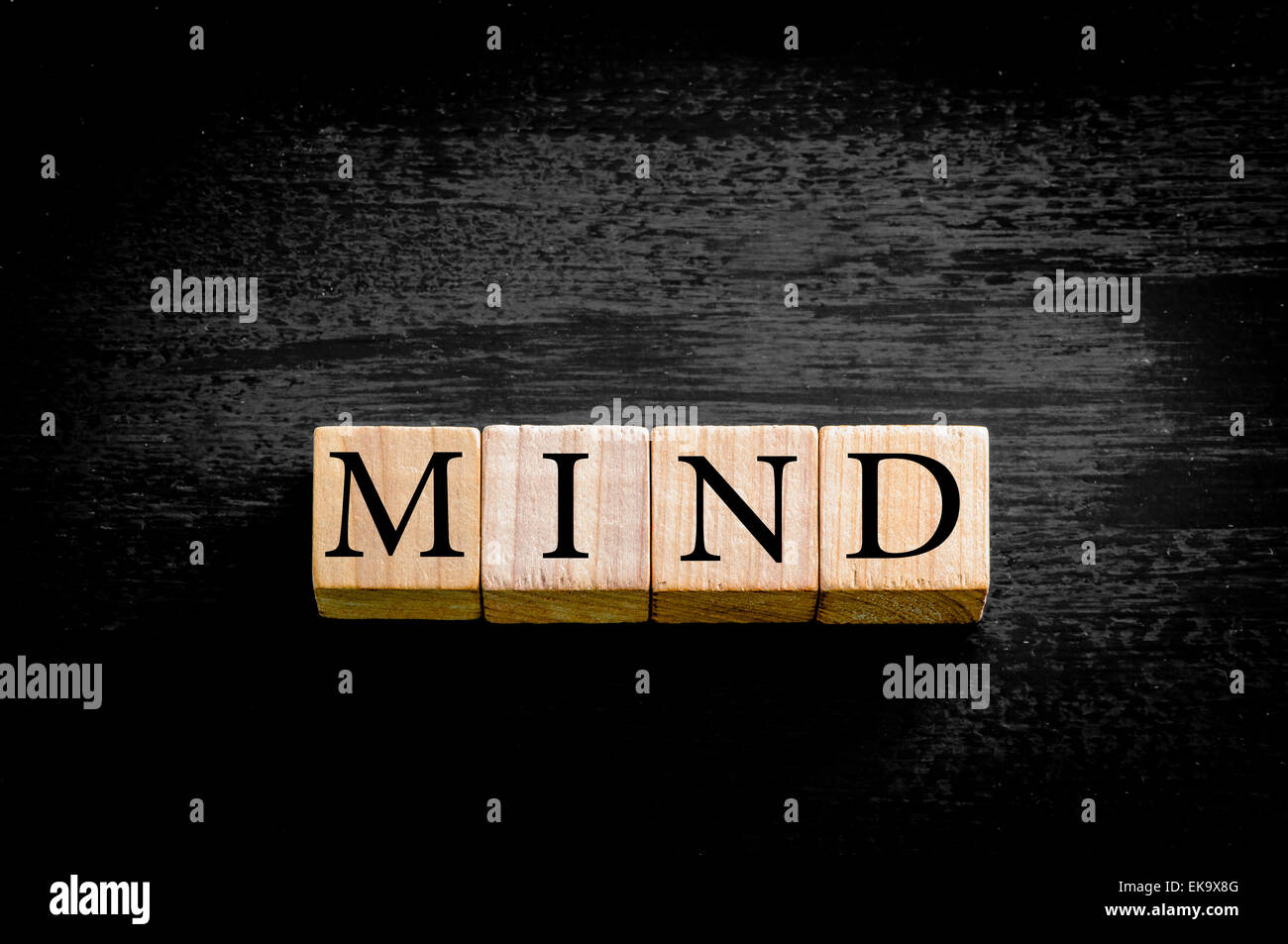 Word MIND. Wooden small cubes with letters isolated on black background ...