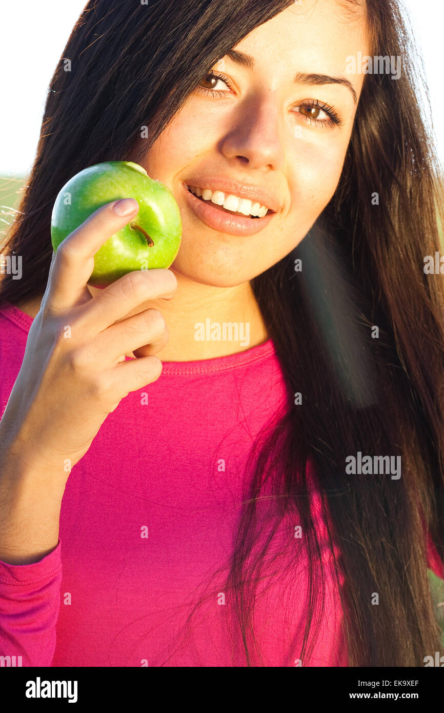 portrait of a beautiful young woman with apple outdoor Stock Photo - Alamy