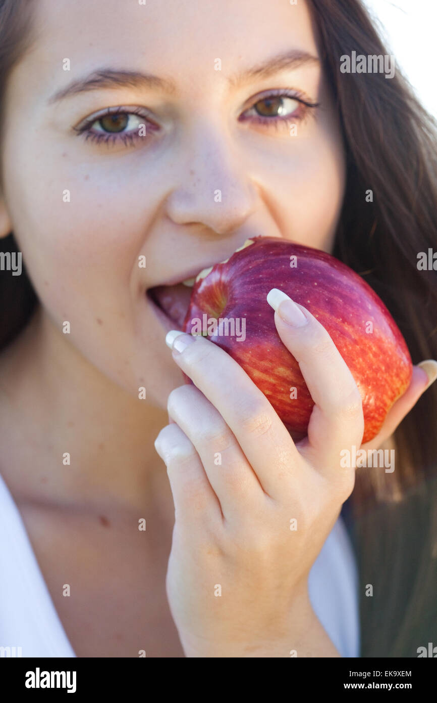 portrait of a beautiful young woman with apple outdoor Stock Photo - Alamy
