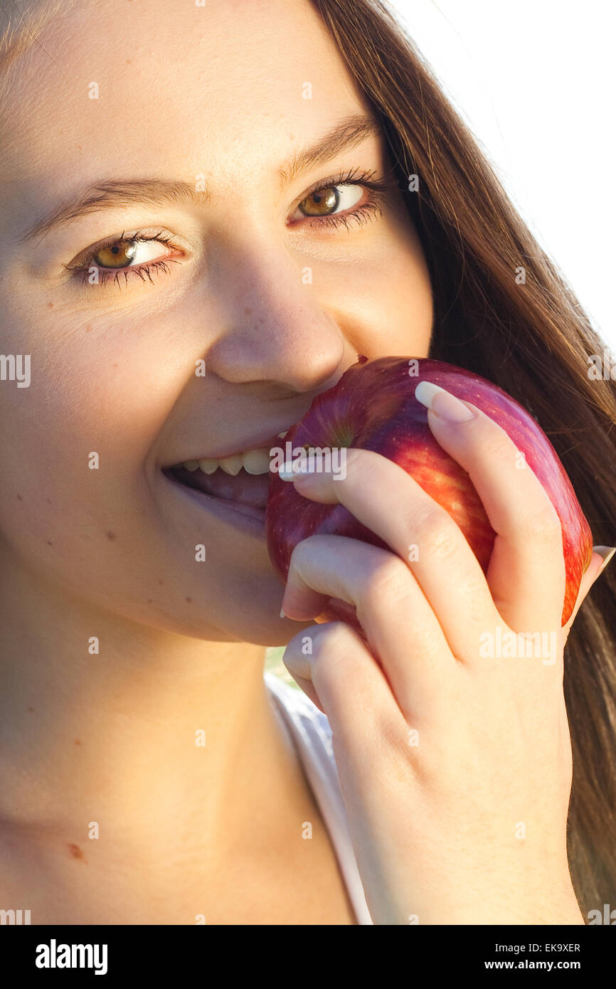 portrait of a beautiful young woman with apple outdoor Stock Photo - Alamy