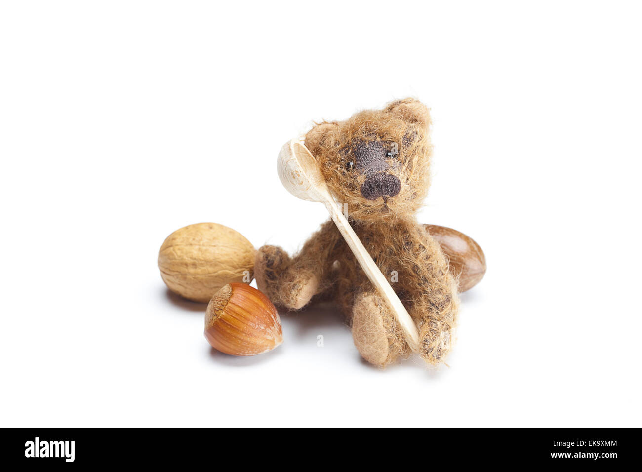Teddy Bear, nuts and wooden spoon isolated on white Stock Photo - Alamy
