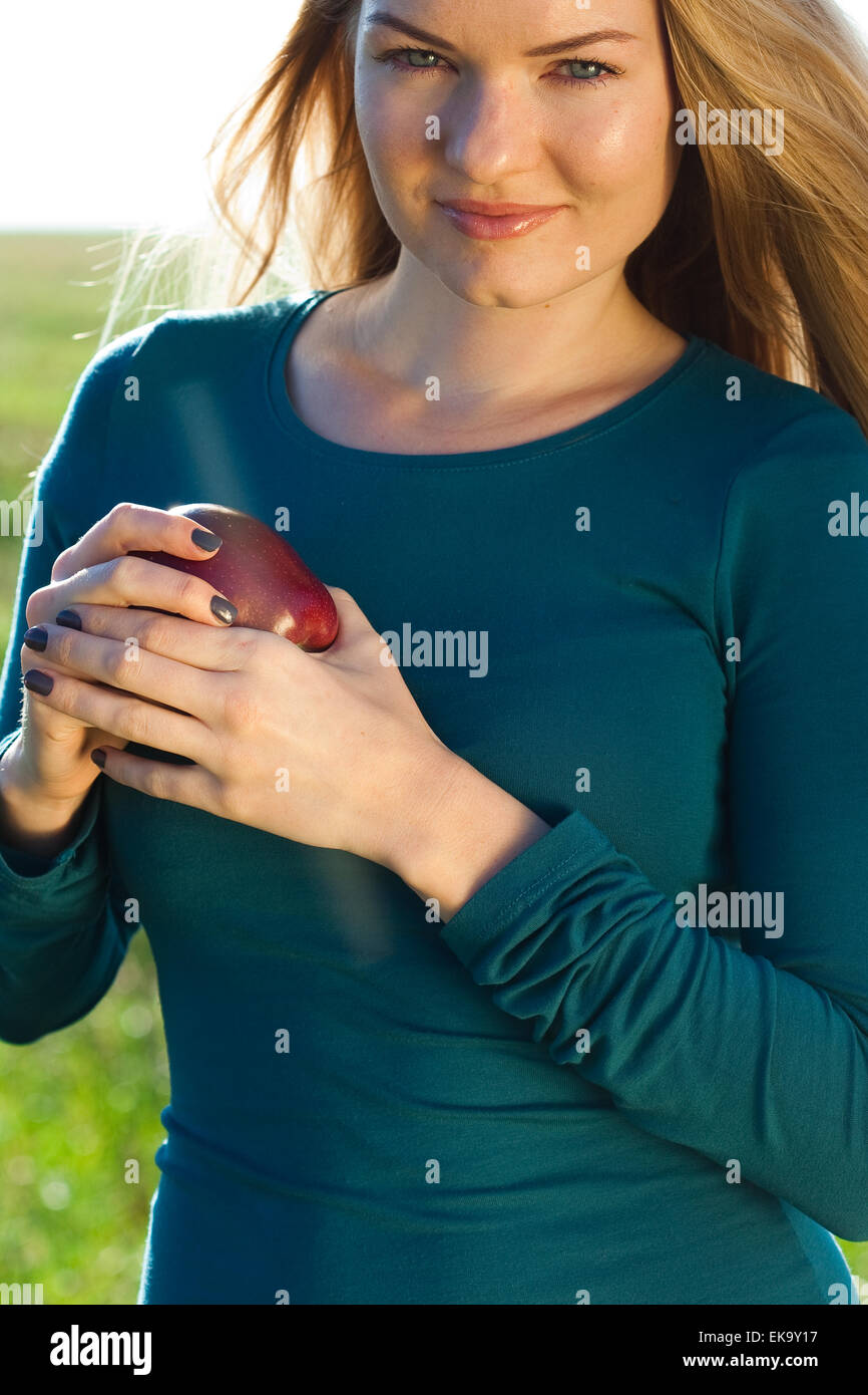 portrait of a beautiful young woman with apple outdoor Stock Photo - Alamy