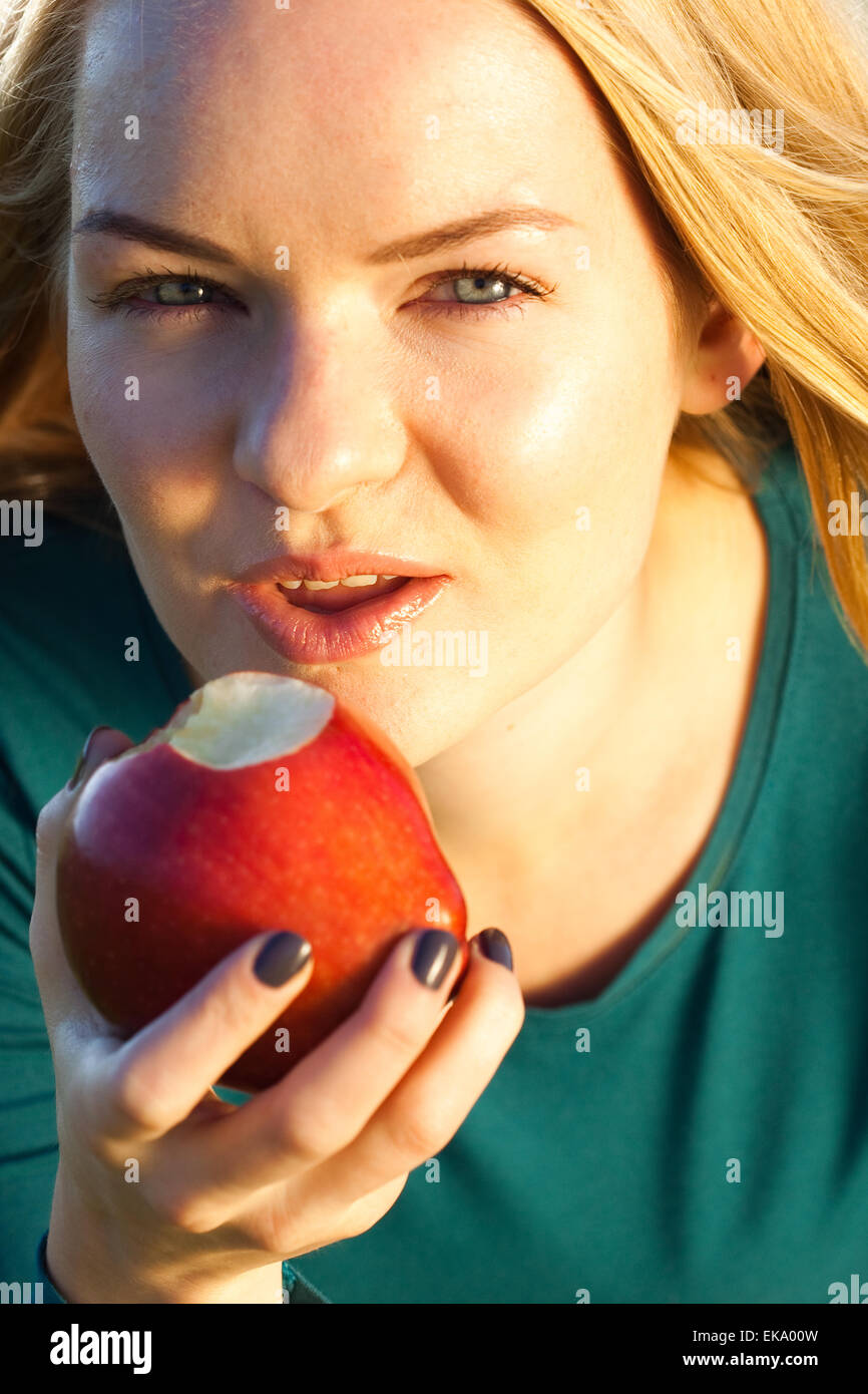 portrait of a beautiful young woman with apple outdoor Stock Photo - Alamy