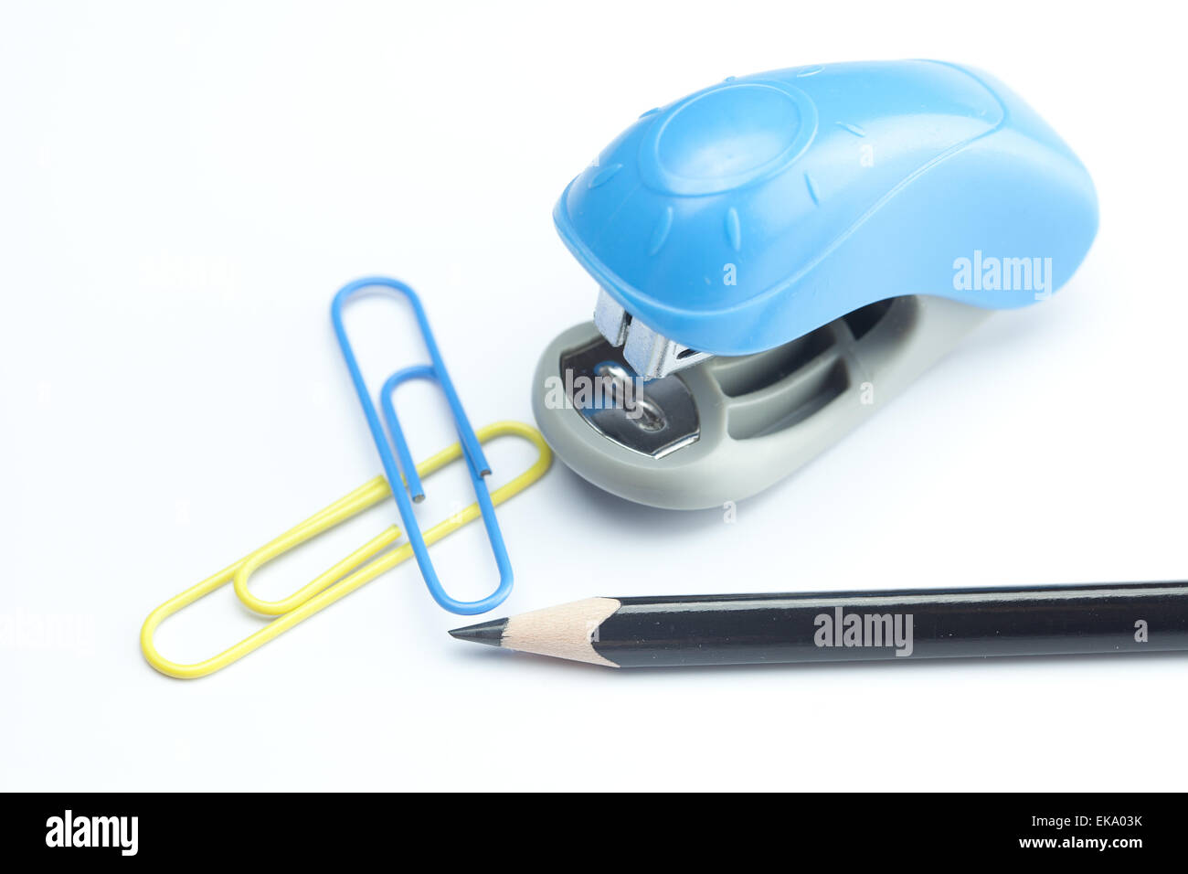 stapler, a pencil and paper clip isolated on white Stock Photo - Alamy