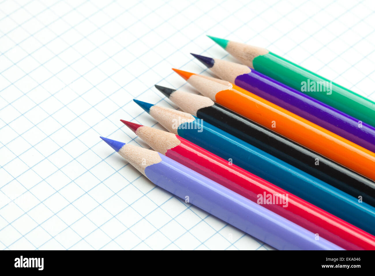 plaid notebook with a spiral and colored pencil Stock Photo - Alamy
