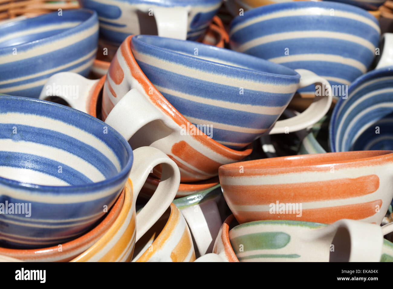 ceramic cups in a basket at the fair Stock Photo - Alamy
