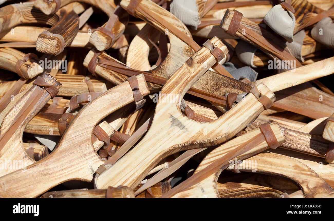background of wooden slingshots at the fair Stock Photo - Alamy