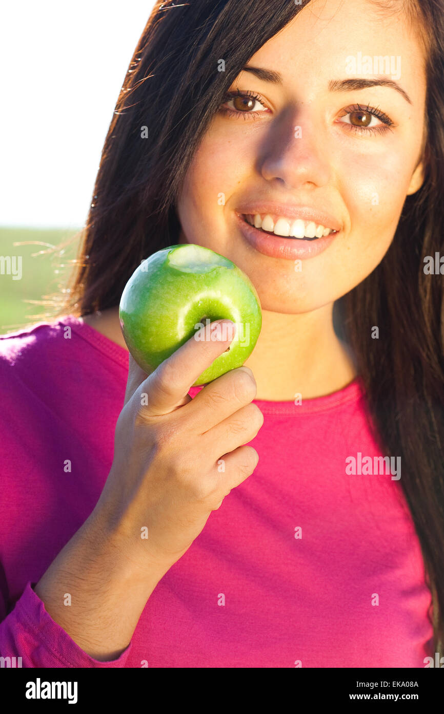 portrait of a beautiful young woman with apple outdoor Stock Photo - Alamy