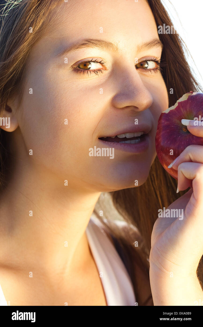 portrait of a beautiful young woman with apple outdoor Stock Photo - Alamy