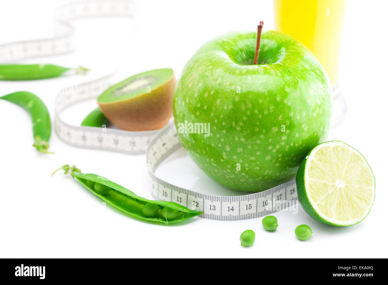 juice,apple,lime,peas,kiwi and measure tape isolated on white Stock ...