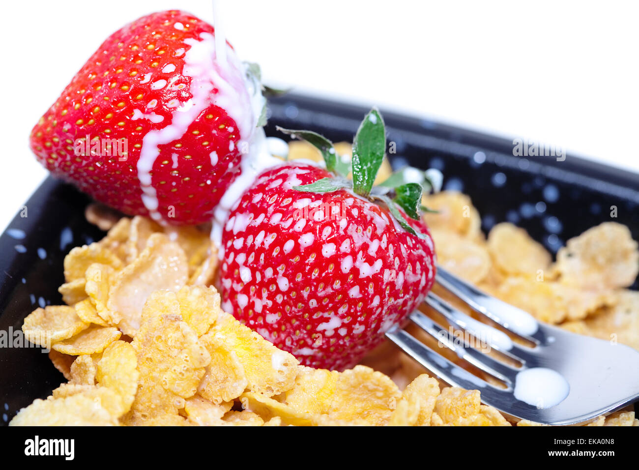 strawberry,milk,fork and flakes in a bowl isolated on white Stock Photo ...