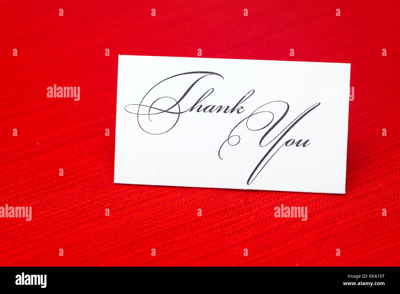 Card signed thank you on a red background Stock Photo - Alamy
