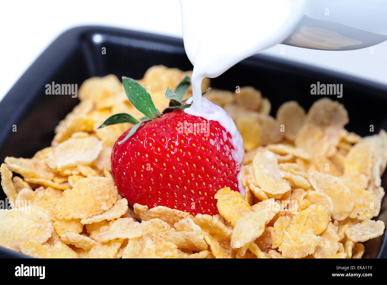 strawberry,milk and flakes in a bowl isolated on white Stock Photo - Alamy