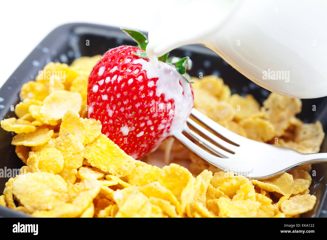 strawberry,milk,fork and flakes in a bowl isolated on white Stock Photo ...