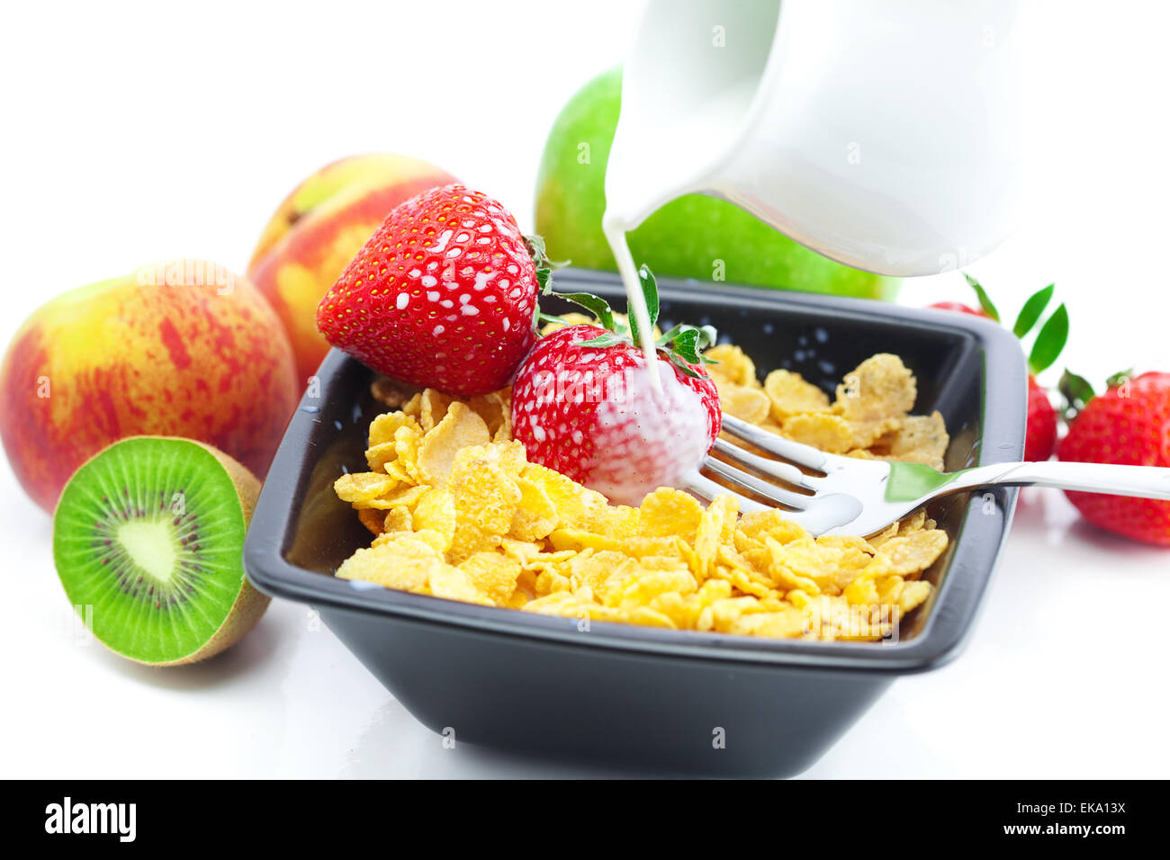 strawberry, peach, apple, kiwi, fork, milk and flakes in a bowl Stock ...