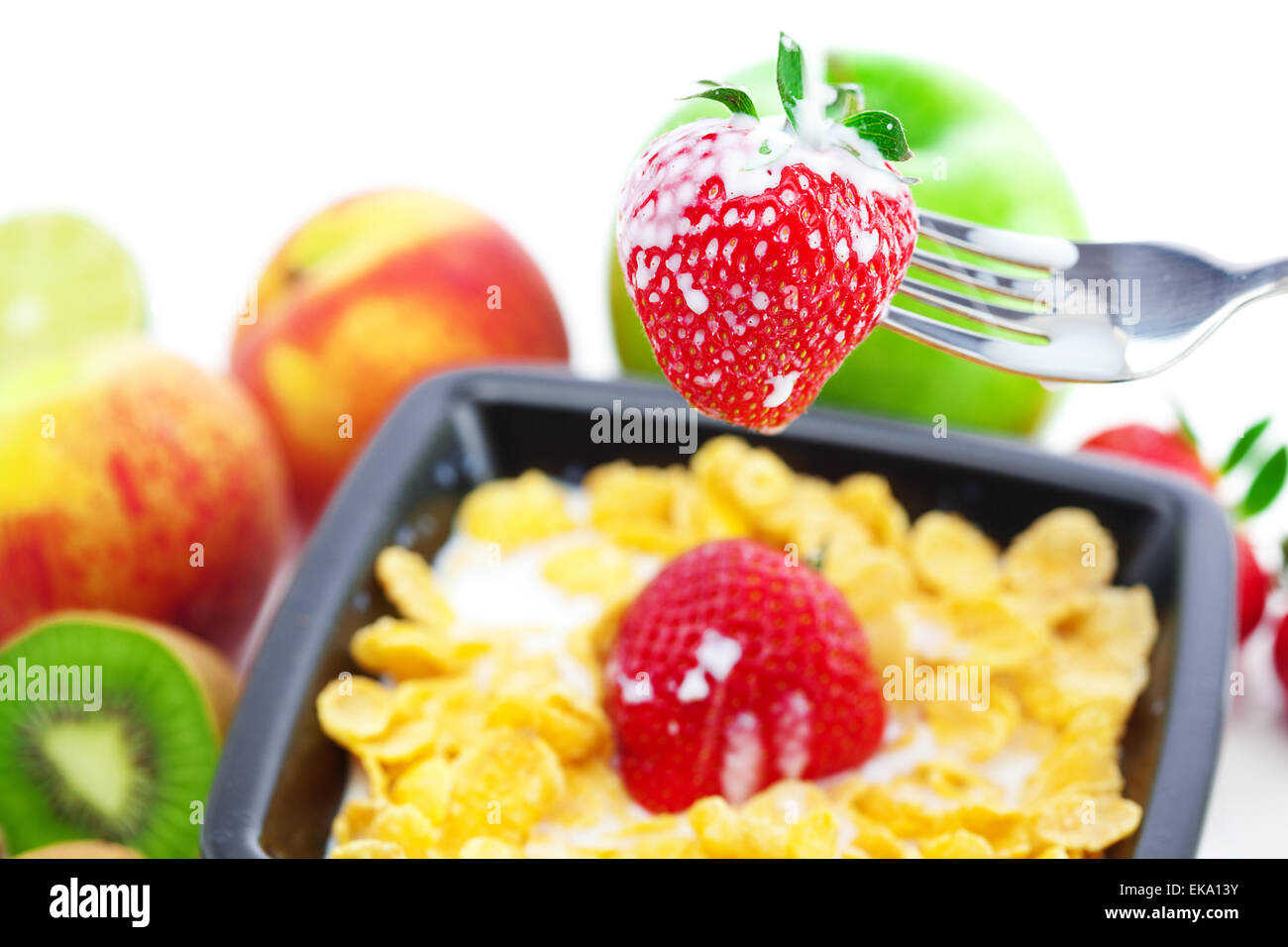 strawberry, peach, apple, kiwi, fork, milk and flakes in a bowl Stock ...
