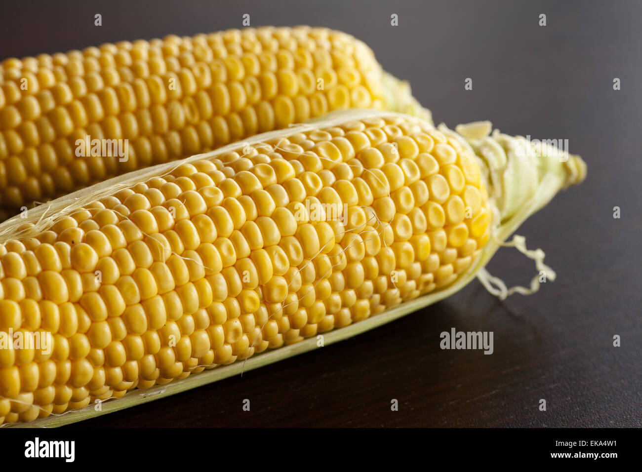 corn lying on a wooden table Stock Photo - Alamy