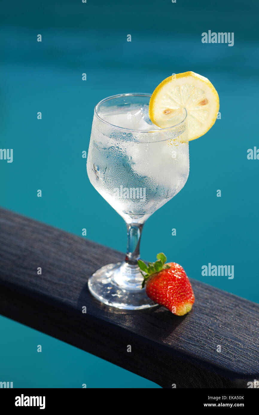 Swimming pool, lounge, a wine glass with ice, lemon and strawber Stock ...