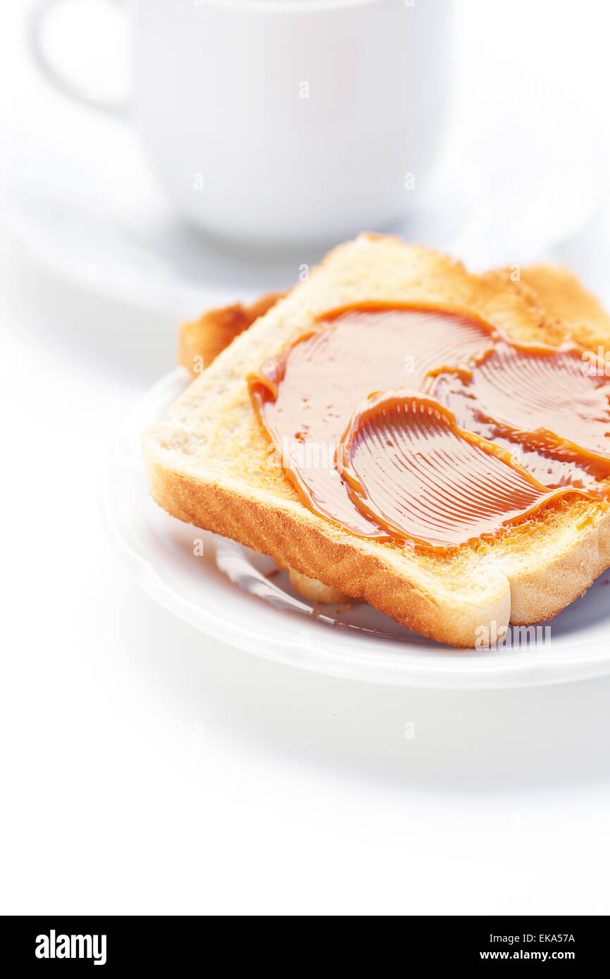 tea and toast with caramel isolated on white Stock Photo - Alamy
