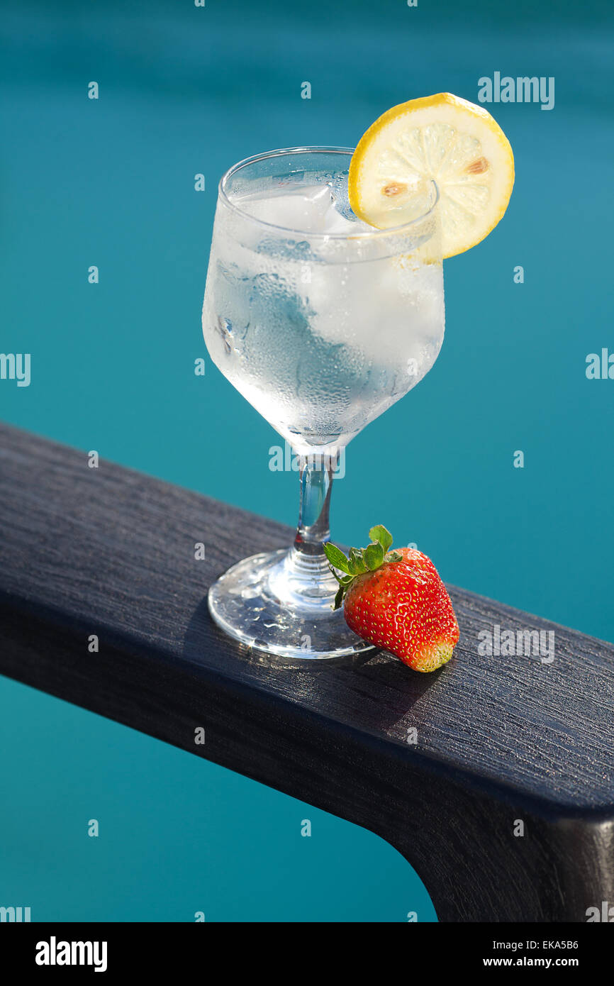 Swimming pool, lounge, a wine glass with ice, lemon and strawber Stock ...