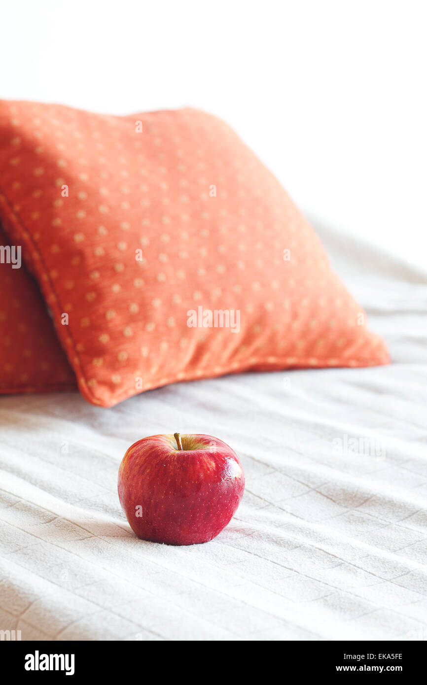 apple on the bed with two pillows Stock Photo - Alamy