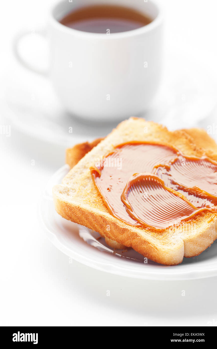 tea and toast with caramel isolated on white Stock Photo - Alamy