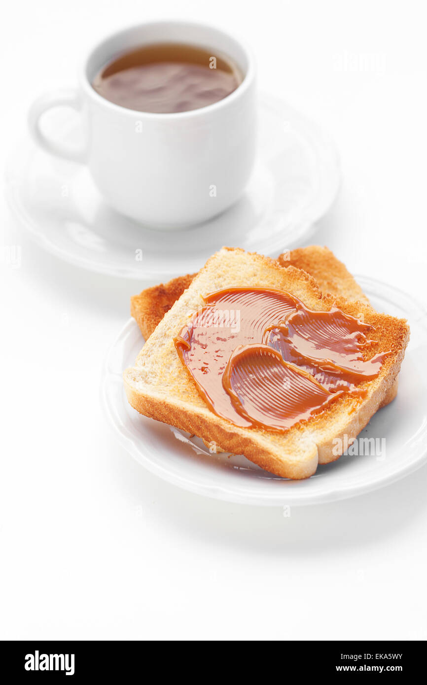tea and toast with caramel isolated on white Stock Photo - Alamy