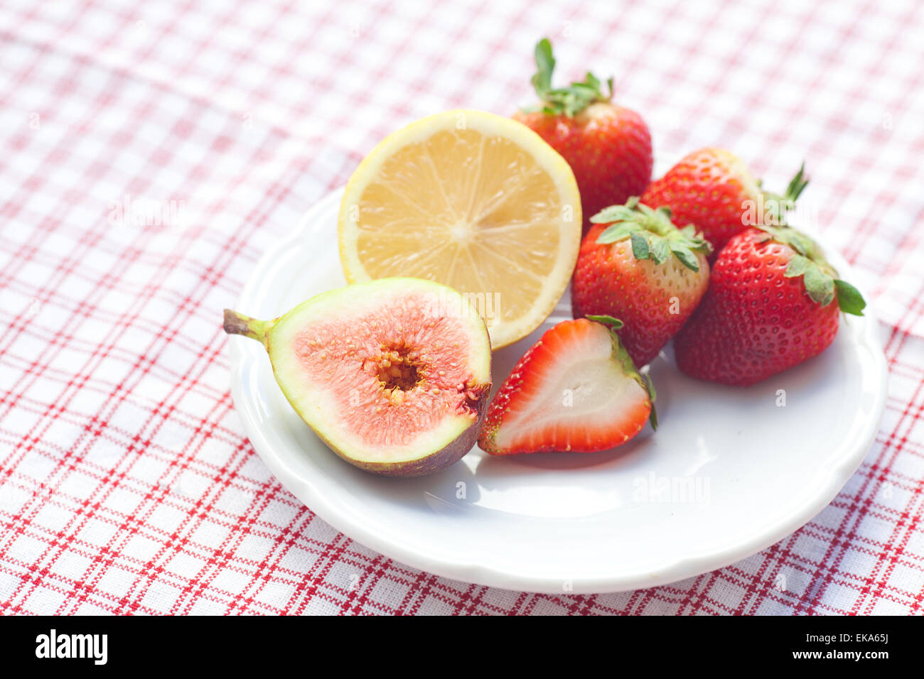 lemon, fig and strawberries on a plate Stock Photo - Alamy