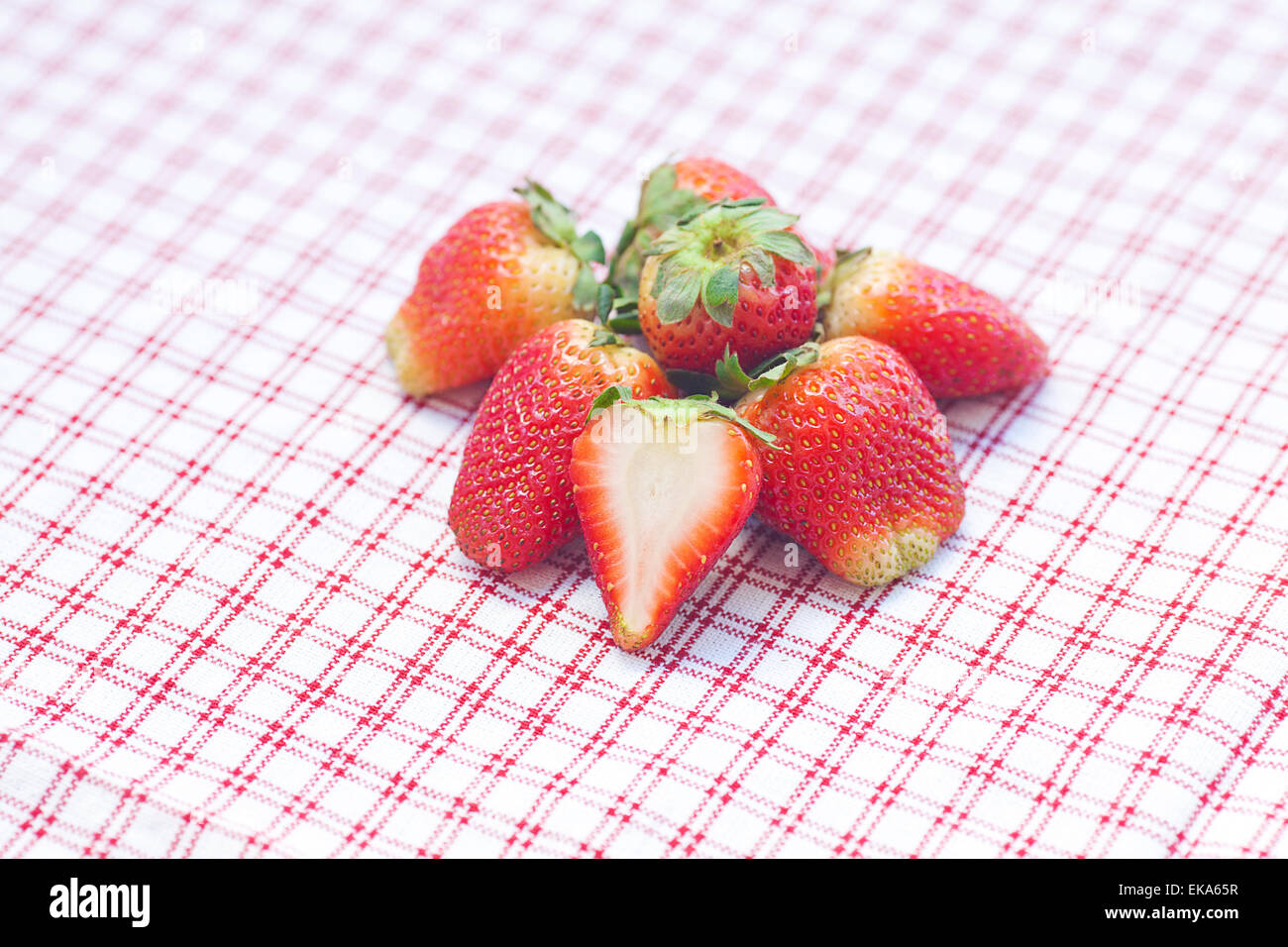 strawberry lying on plaid fabric Stock Photo - Alamy
