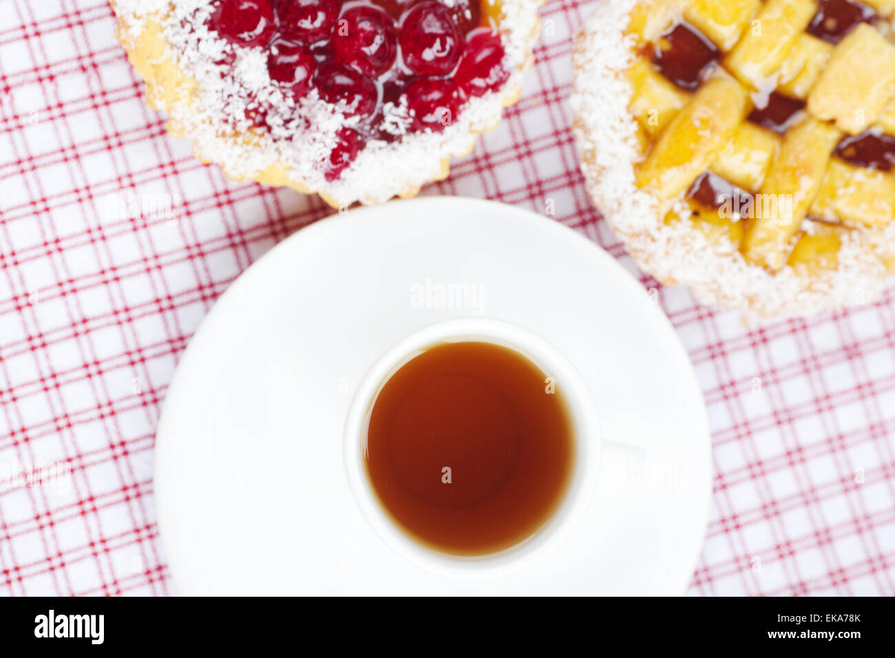 beautiful cake with berries and tea on plaid fabric Stock Photo - Alamy