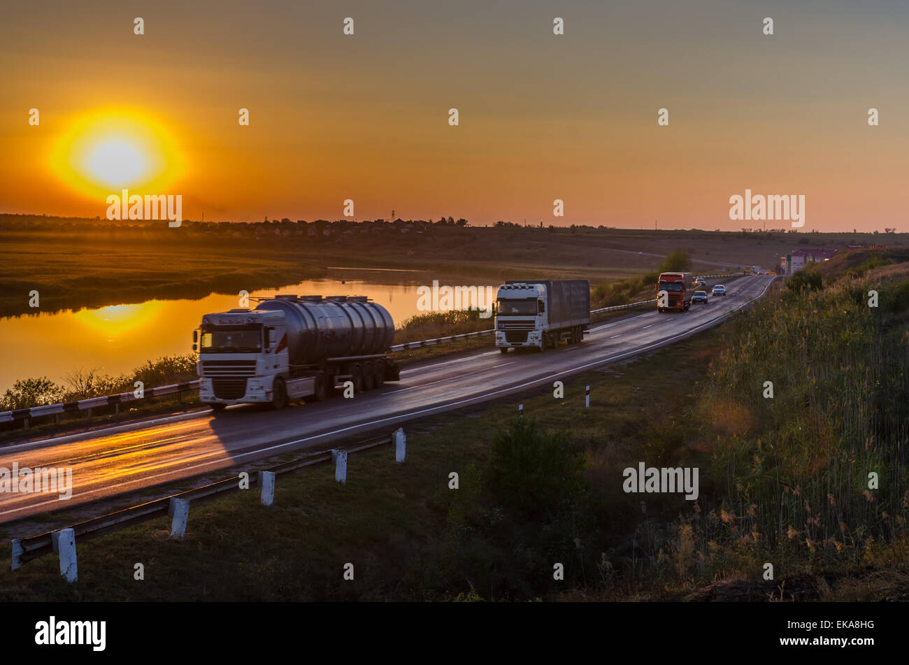 sunset over road with autos Stock Photo - Alamy