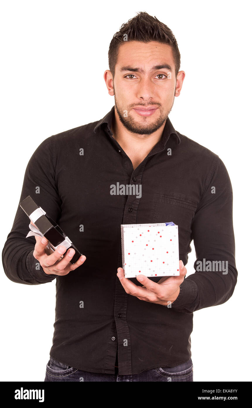 charming young man holding a gift box looking disappointed Stock Photo ...