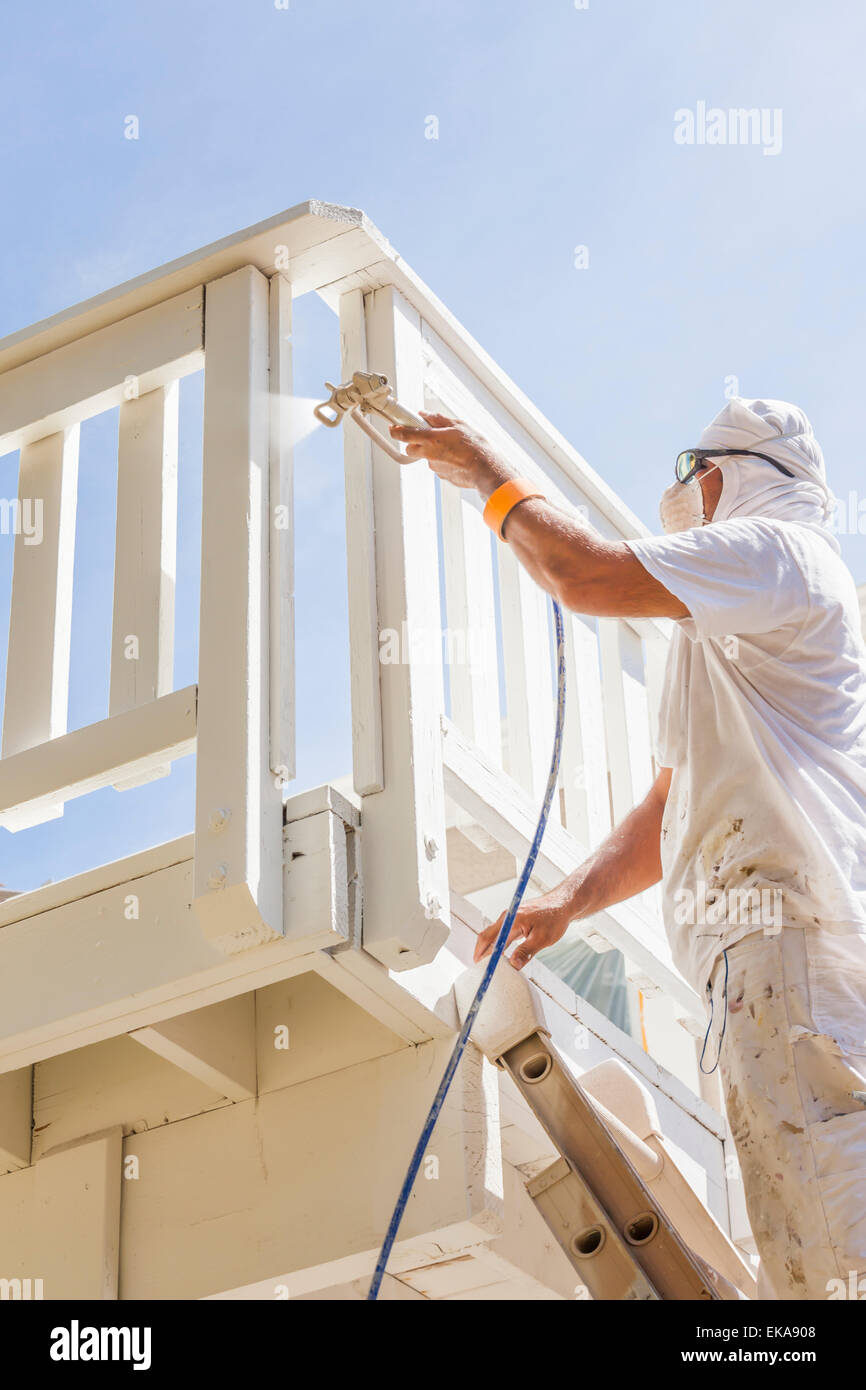 House Painter Wearing Facial Protection Spray Painting A Deck of A Home ...