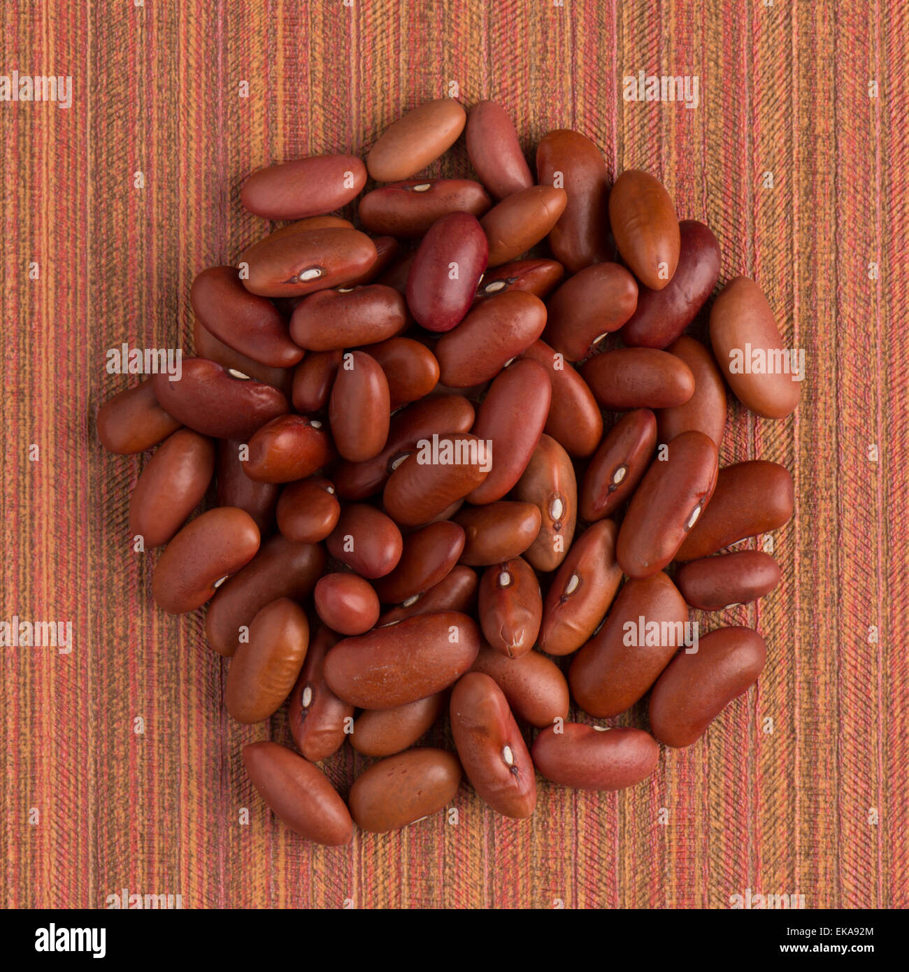 Circle of red beans on red vinyl background Stock Photo - Alamy