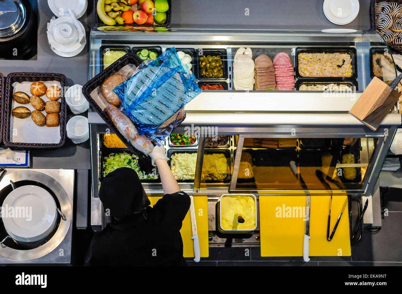 A person reaches into a food counter at a sandwich bar Stock Photo - Alamy