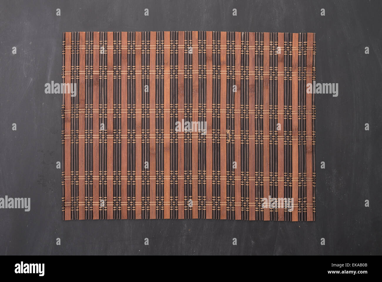 Bamboo place mat on wooden deck table Stock Photo - Alamy