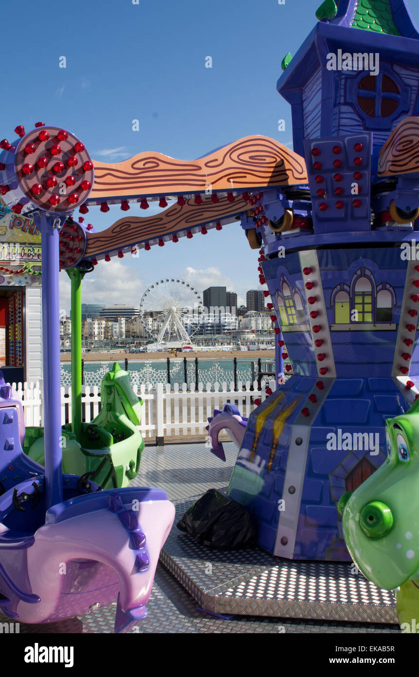 Brighton pier rides in foreground with the brighton eye in the distance ...