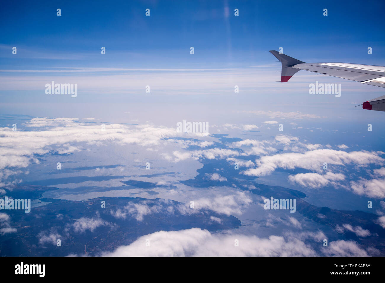 Airplane wing from plane window and landscape below Stock Photo - Alamy