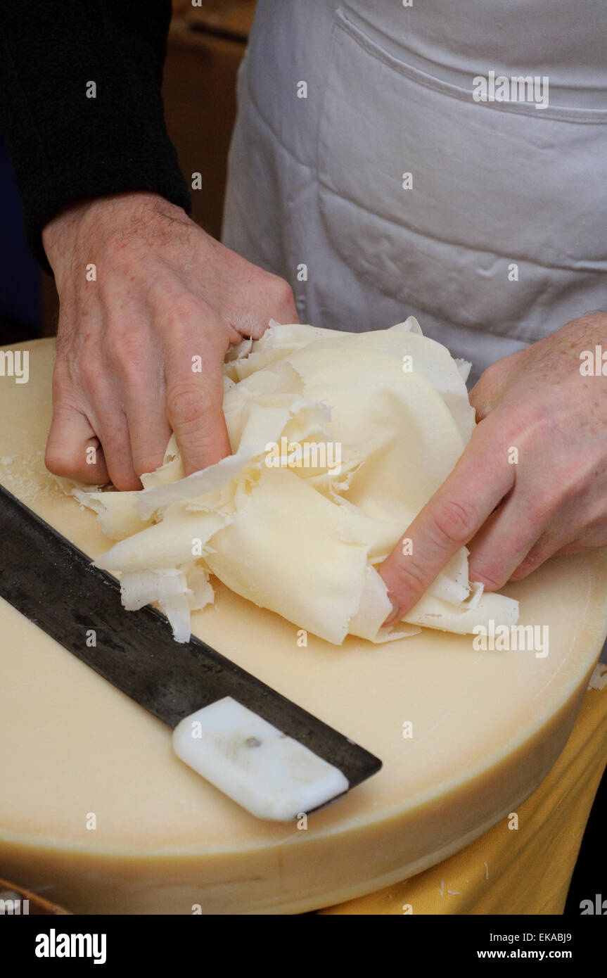 Italy, Lombardy, Lodi, Making of Raspadùra Cheese Sliced Young Parmesan ...