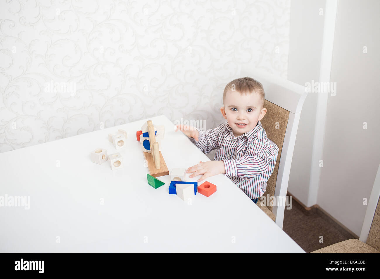 Boy playing with blocks at table hi-res stock photography and images ...