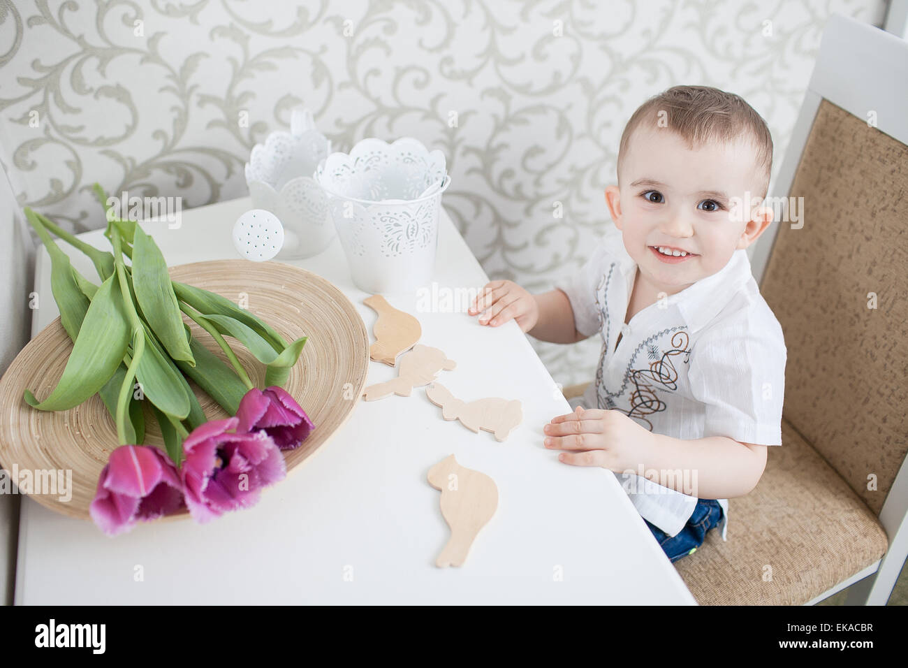 Cute baby boy with tulip Stock Photo - Alamy