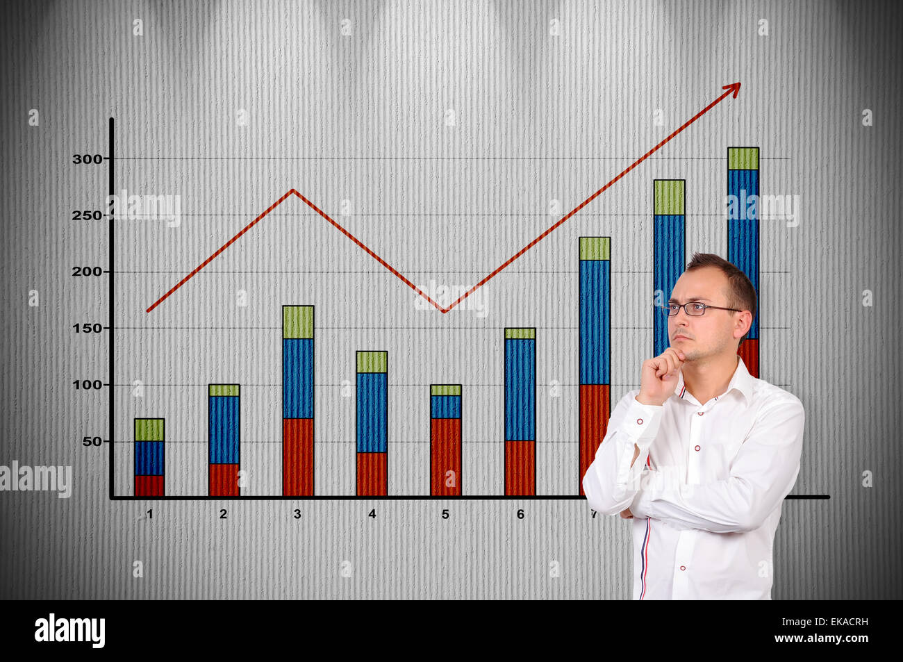 young businessman thinking and drawing graph on concrete wall Stock ...
