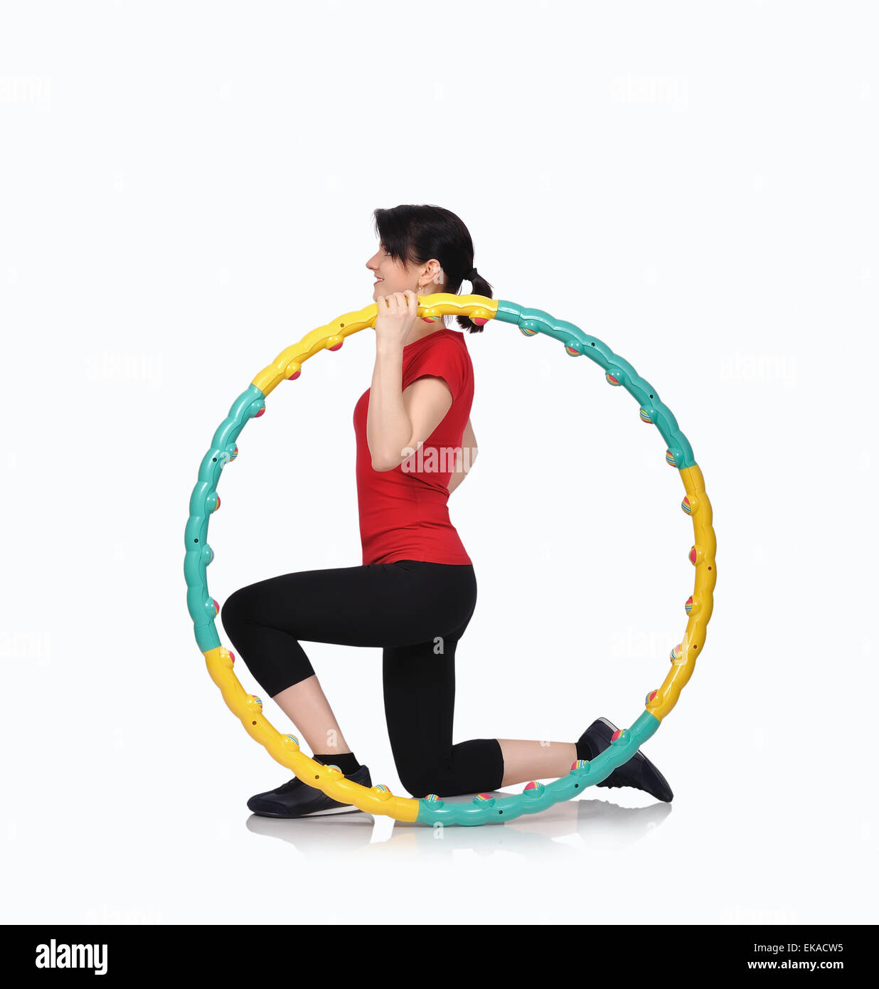 woman sitting with color hula hoop on white background Stock Photo - Alamy