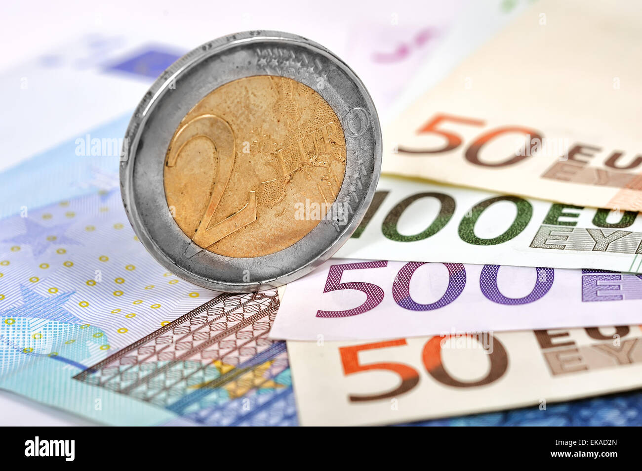Two Euro coin and euro banknotes, close up Stock Photo - Alamy